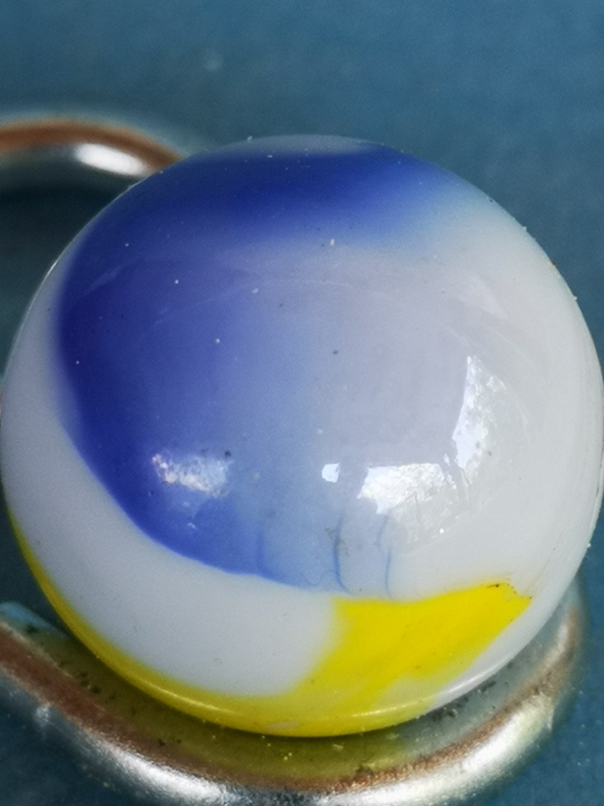 Blue and yellow patch on white..Shooter - Marble I.D.'s - Marble Connection